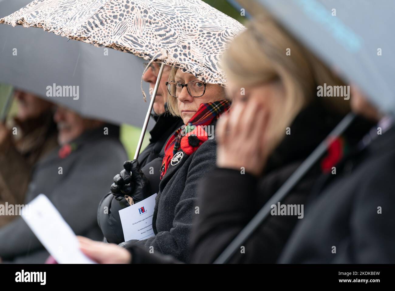 Guests shelter from the rain as they attend the official opening of the ...