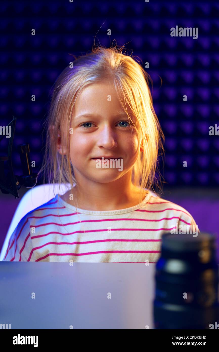 Smiling child girl sitting in recording studio portrait Stock Photo - Alamy