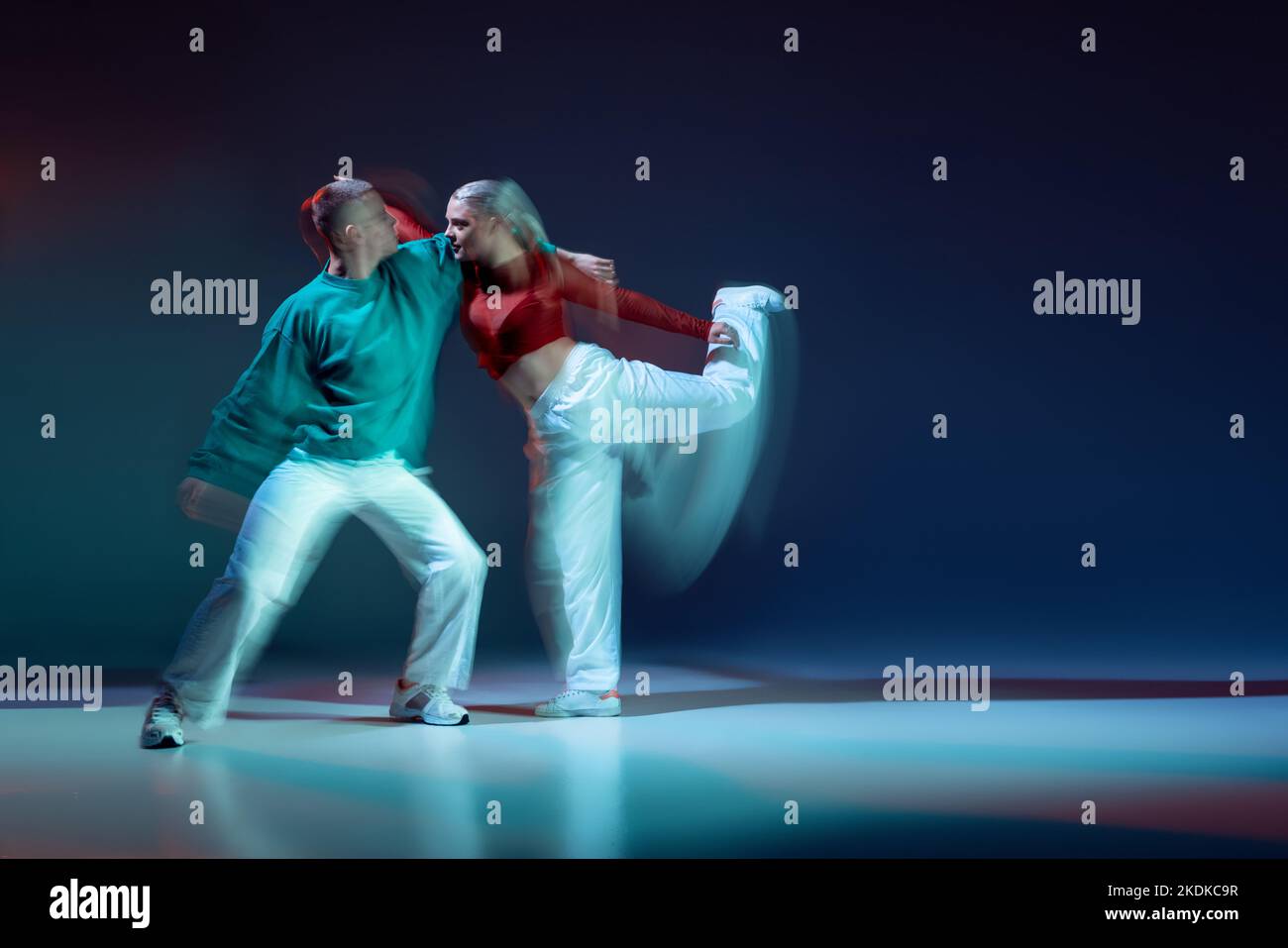Portrait of young couple, man and woman dancing modern style dance ...