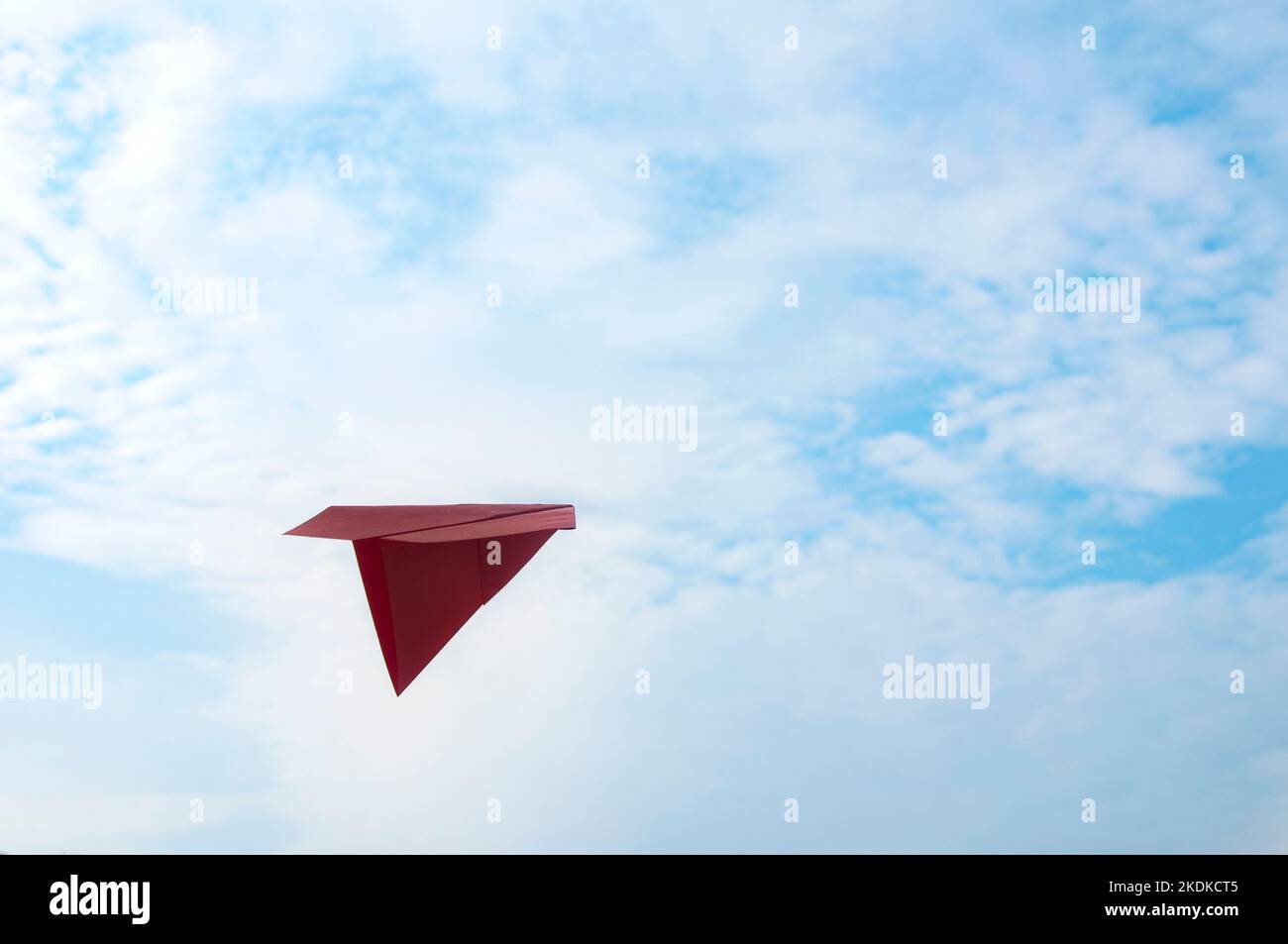 Flying red paper plane on blue sky background Stock Photo - Alamy