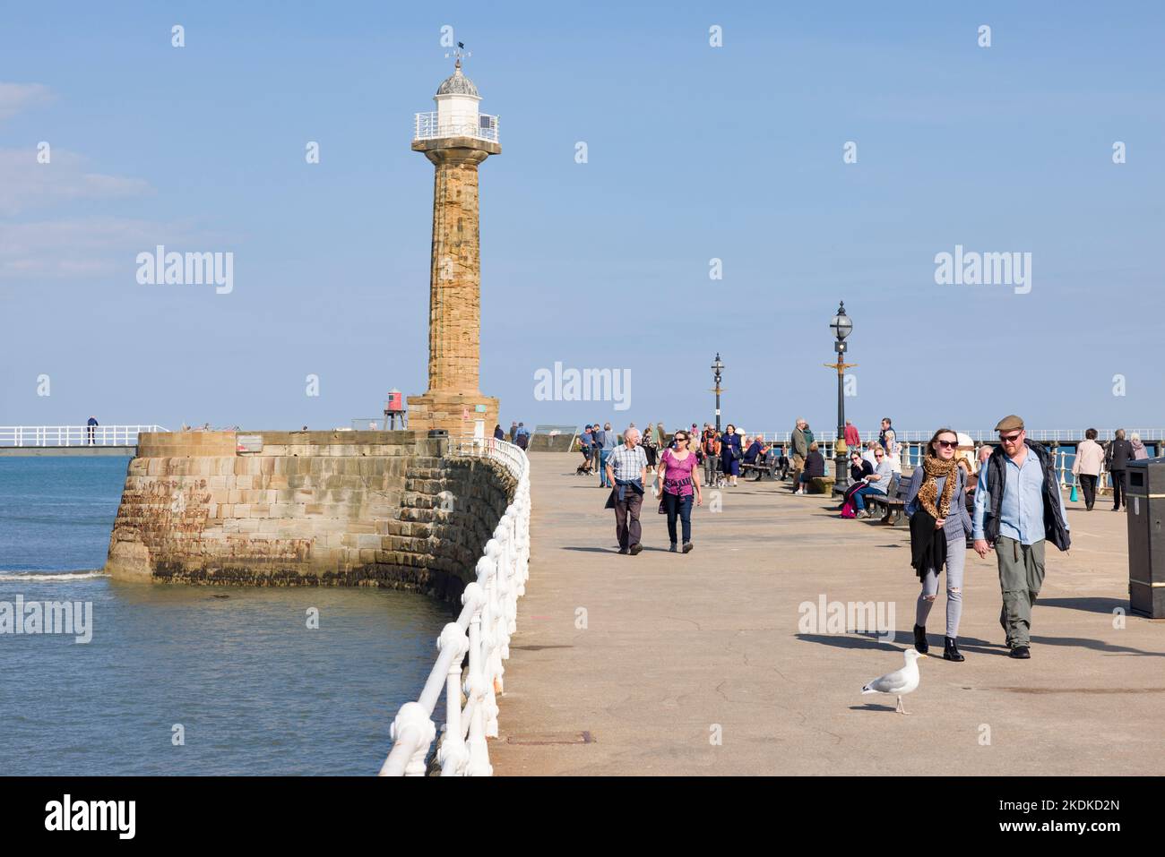 WHITBY, UK - September 21, 2022. Tourists walk along Whitby pier ...