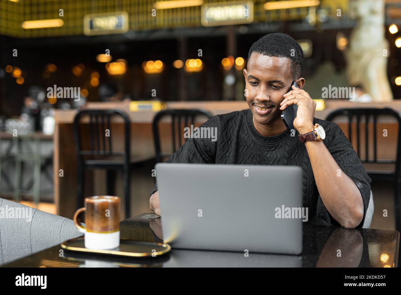 Cheerful young man laptop talking hi-res stock photography and images ...
