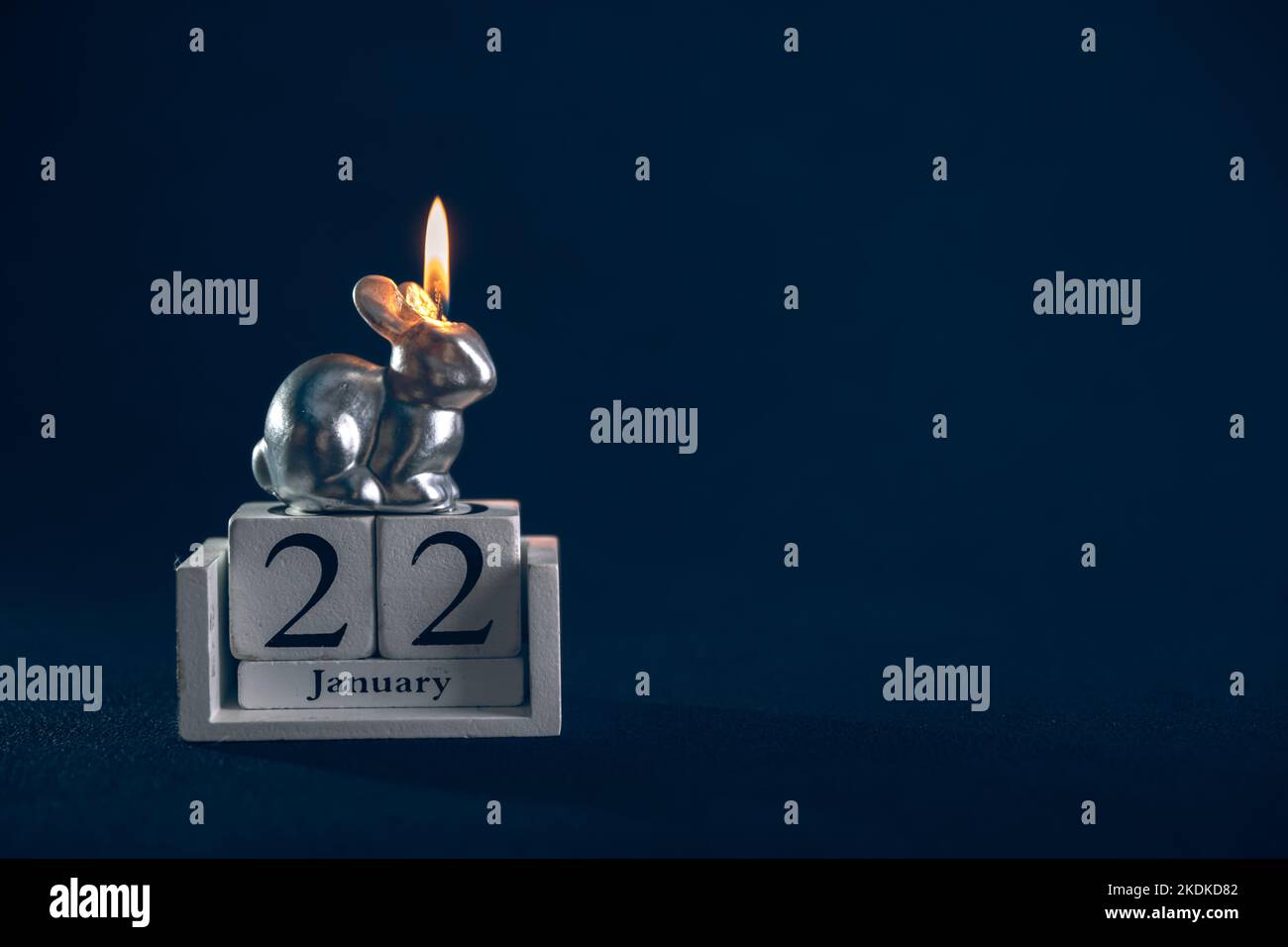 candle in the form of a rabbit symbol of 2023 among the lights ...