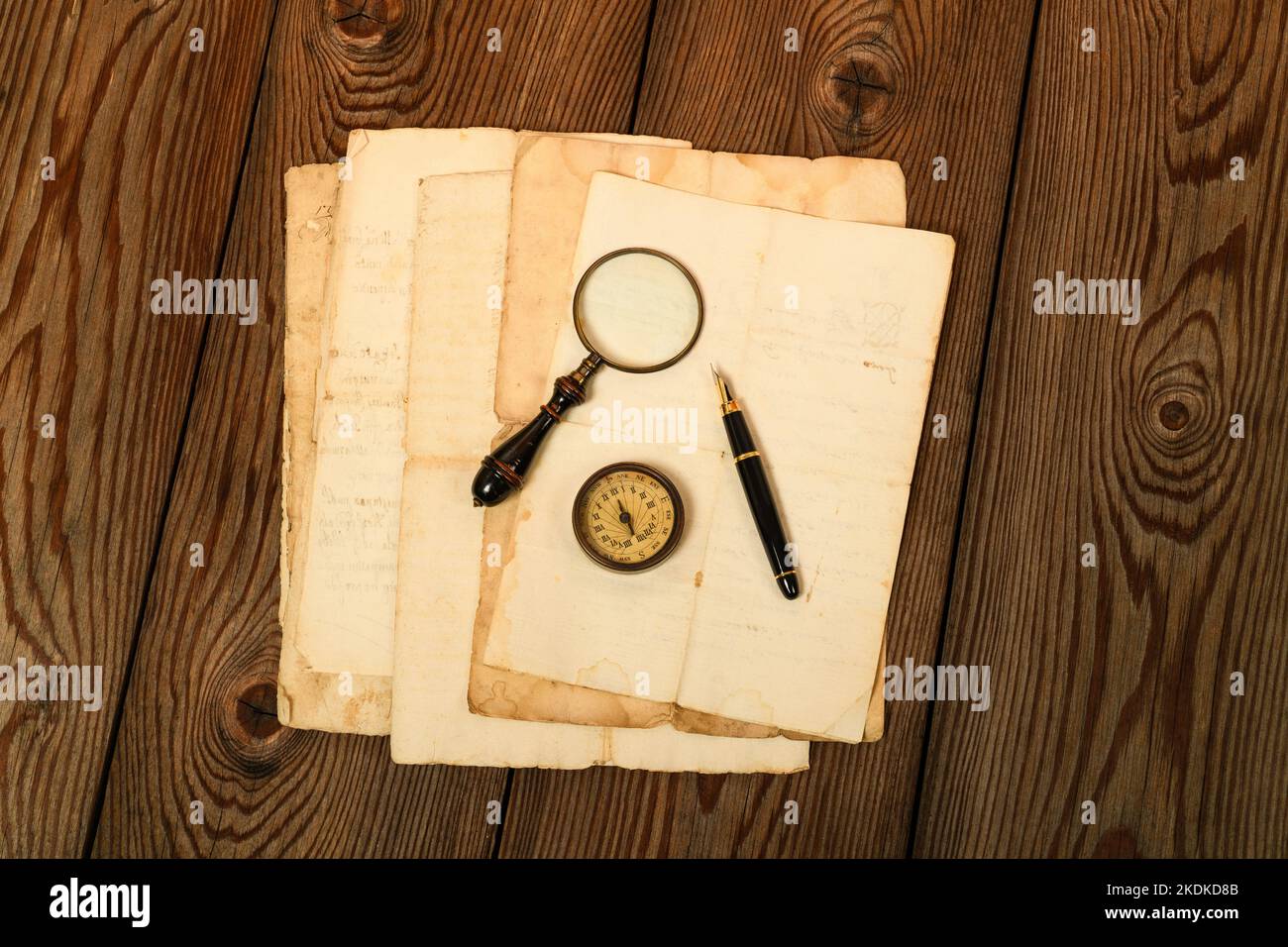 Fountain pen compass and magnifying glass on old sheets Stock Photo - Alamy