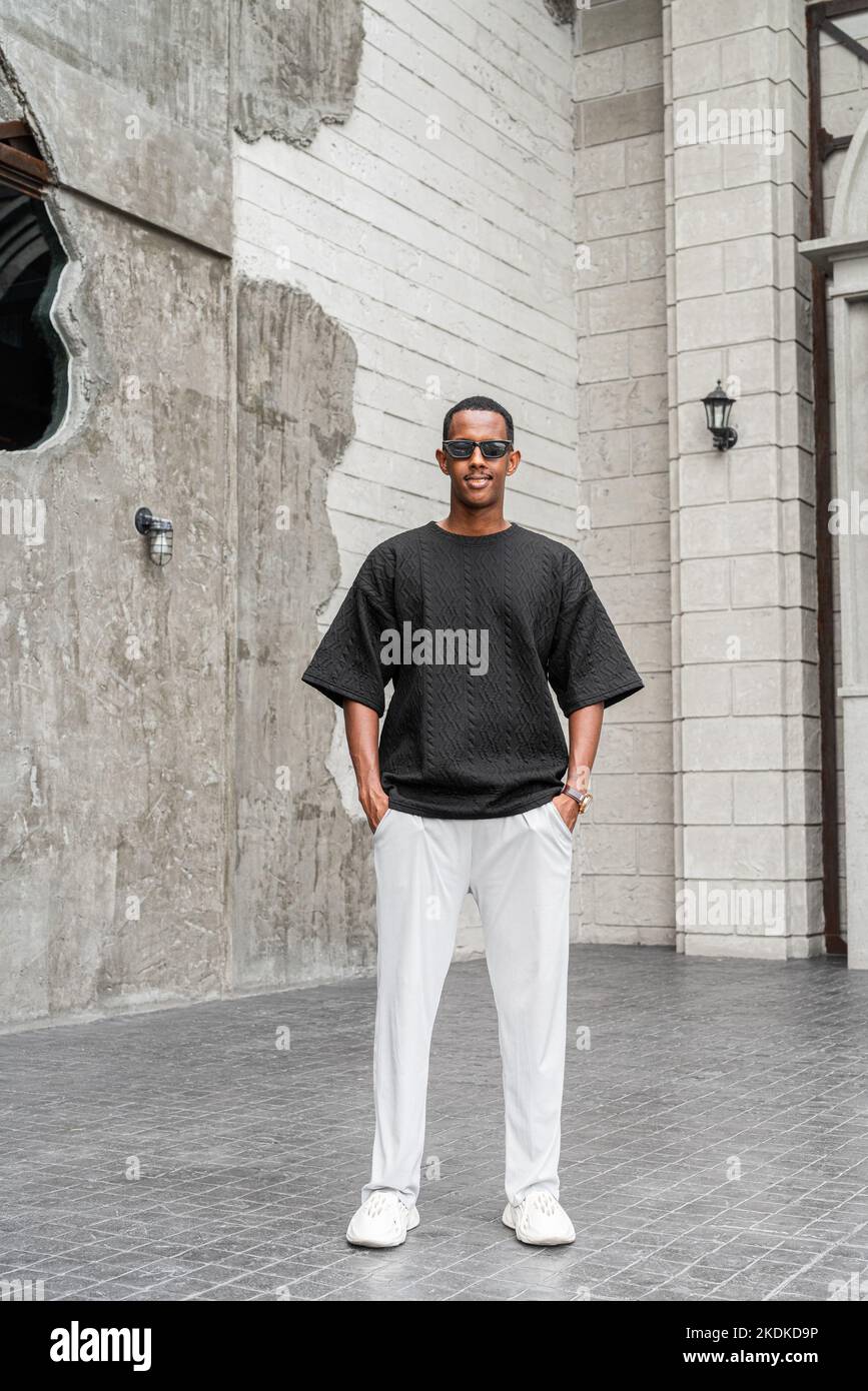 Full body portrait of handsome young African man standing outdoors ...