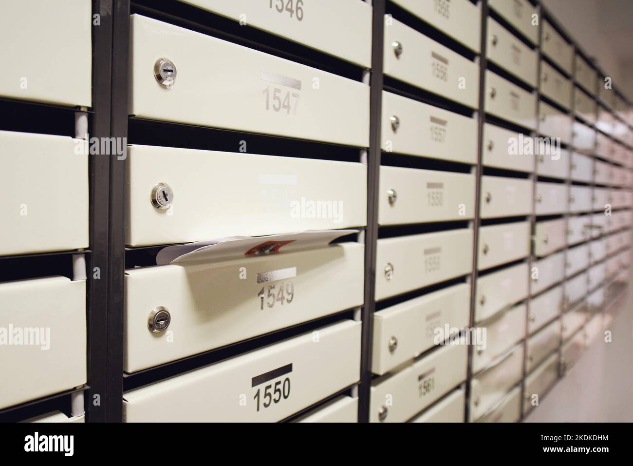 Mailboxes filled with letters and bills in an apartment building. An ...