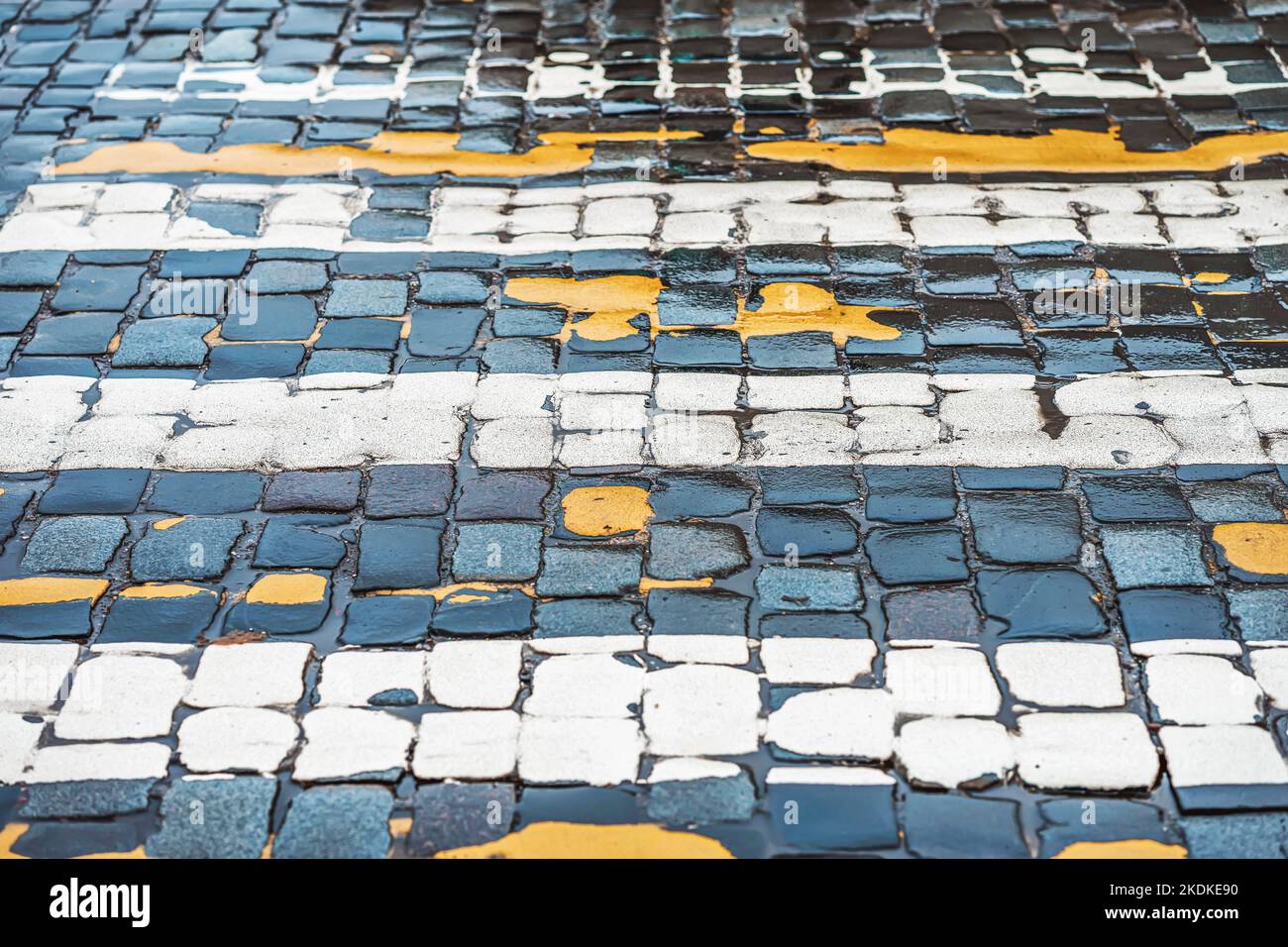 Pedestrian crossing with cobblestone road, nobody.Old stone texture ...