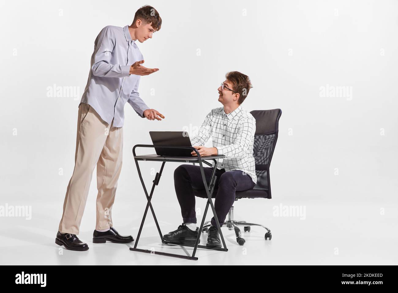 Portrait of two men. IT specialist working together, mentor giving help ...