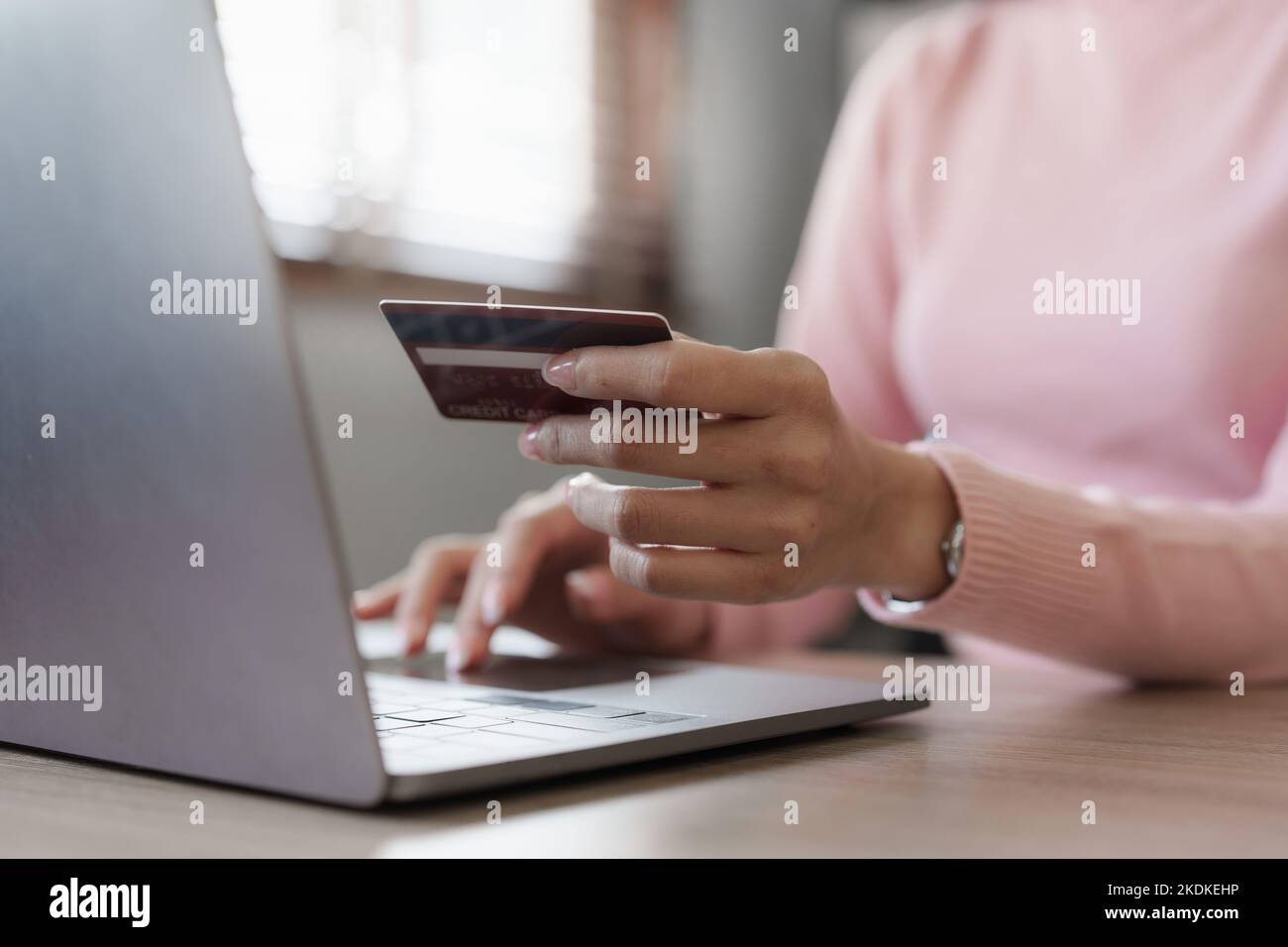 Young person using credit card and laptop computer. Online shopping, e ...