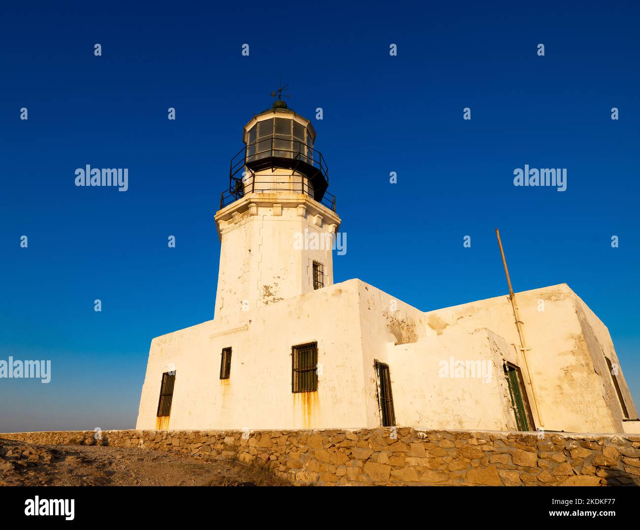 Mykonos old Armenistis lighthouse with a deep blue sky background Stock ...