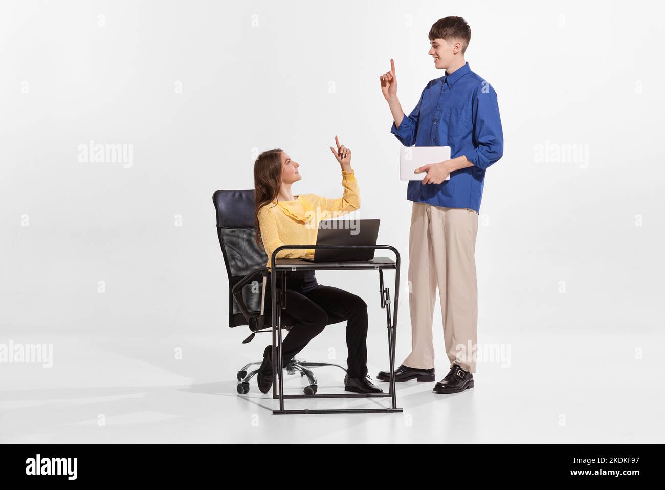 Portrait of two people, employees, man and woman helping each other ...