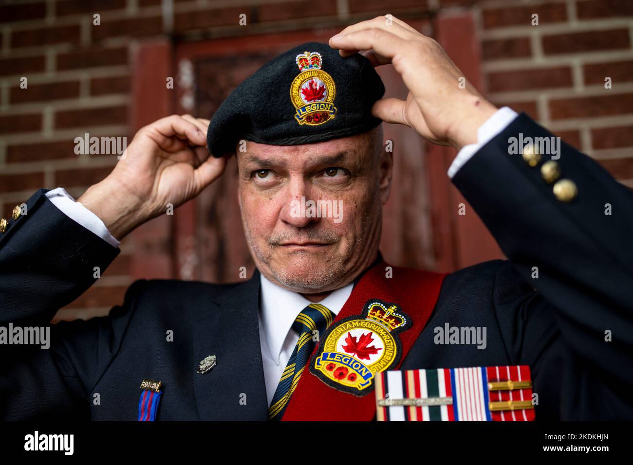 Chief Petty Officer First Class (retired) Jake McDavid dons his beret ...