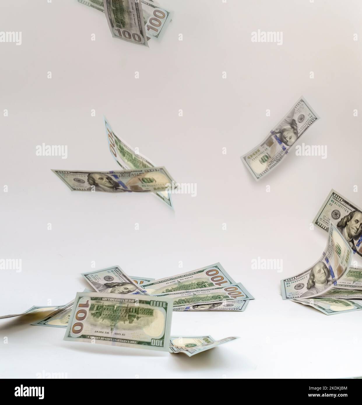 Falling paper money dollar bills on white background Stock Photo - Alamy