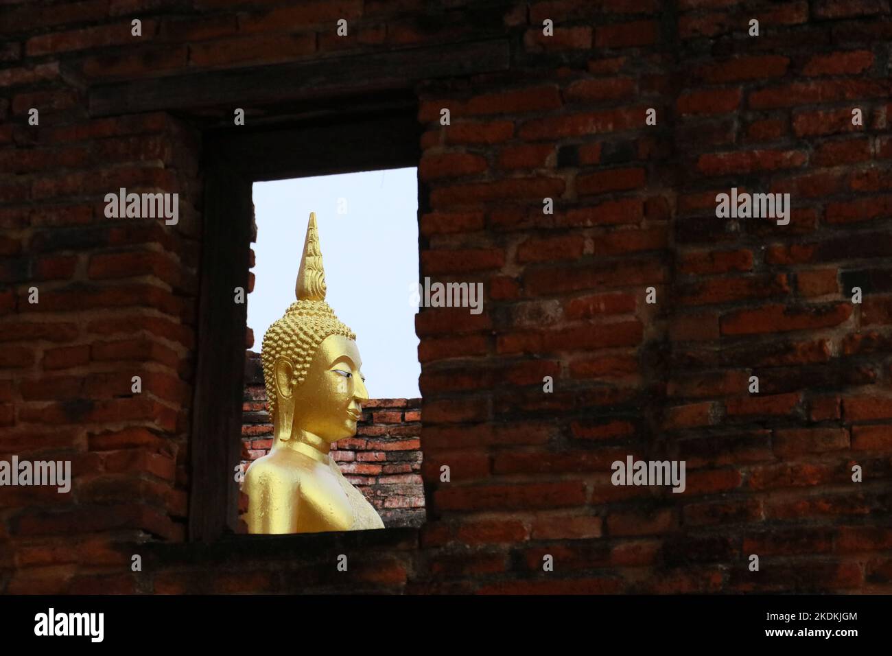 Buddha statue through window at Wat Choeng Tha, Buddhist temple in the ...