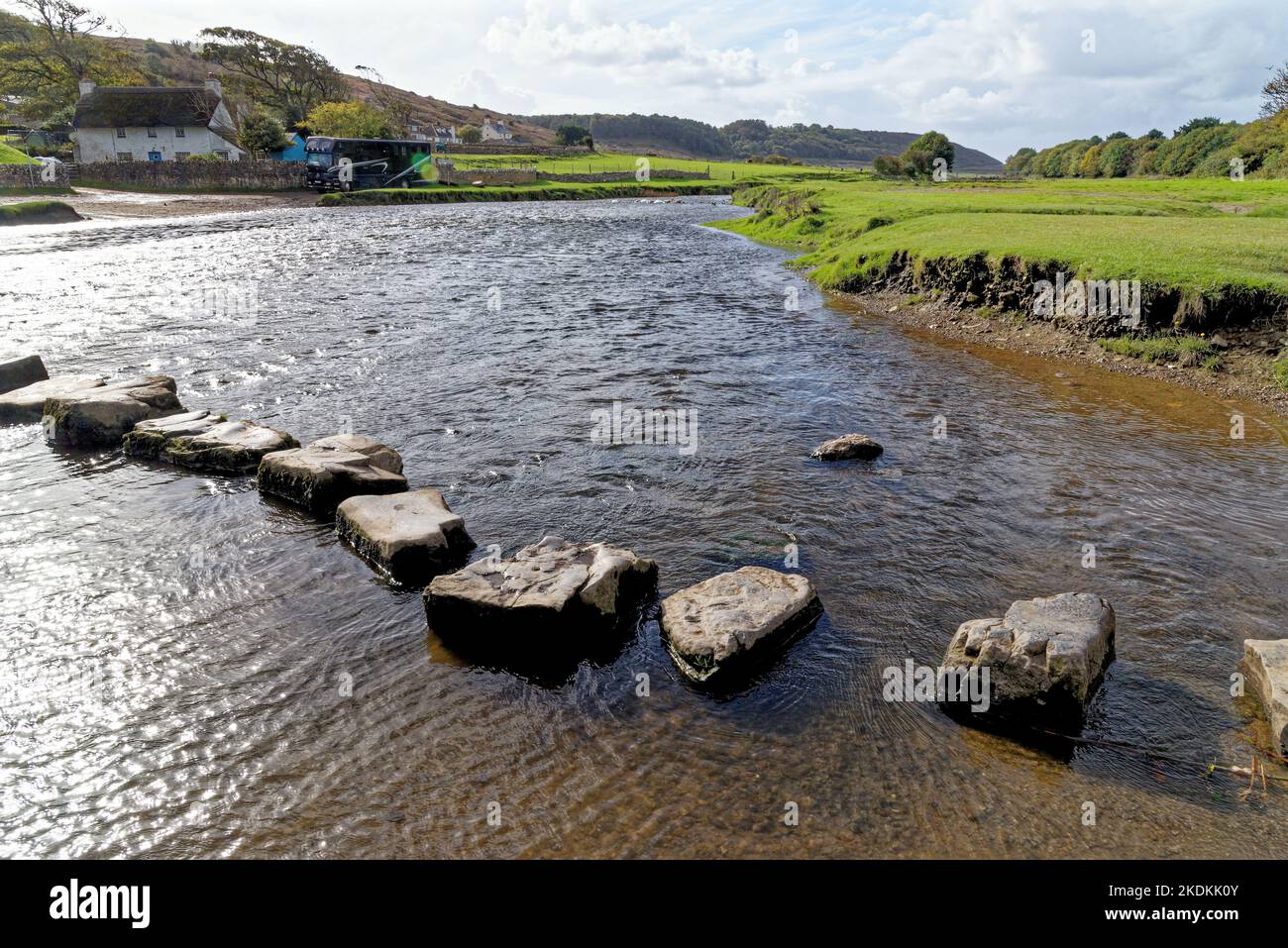 Old stepping stones to cross Ewenny River at Ogmore Castle. Ogmore by ...