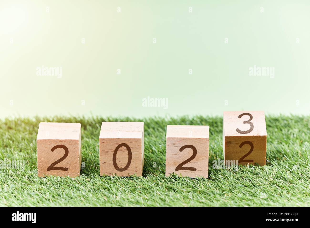 The cube passes from 2022 to 2023 in a grassy meadow. New year concept ...