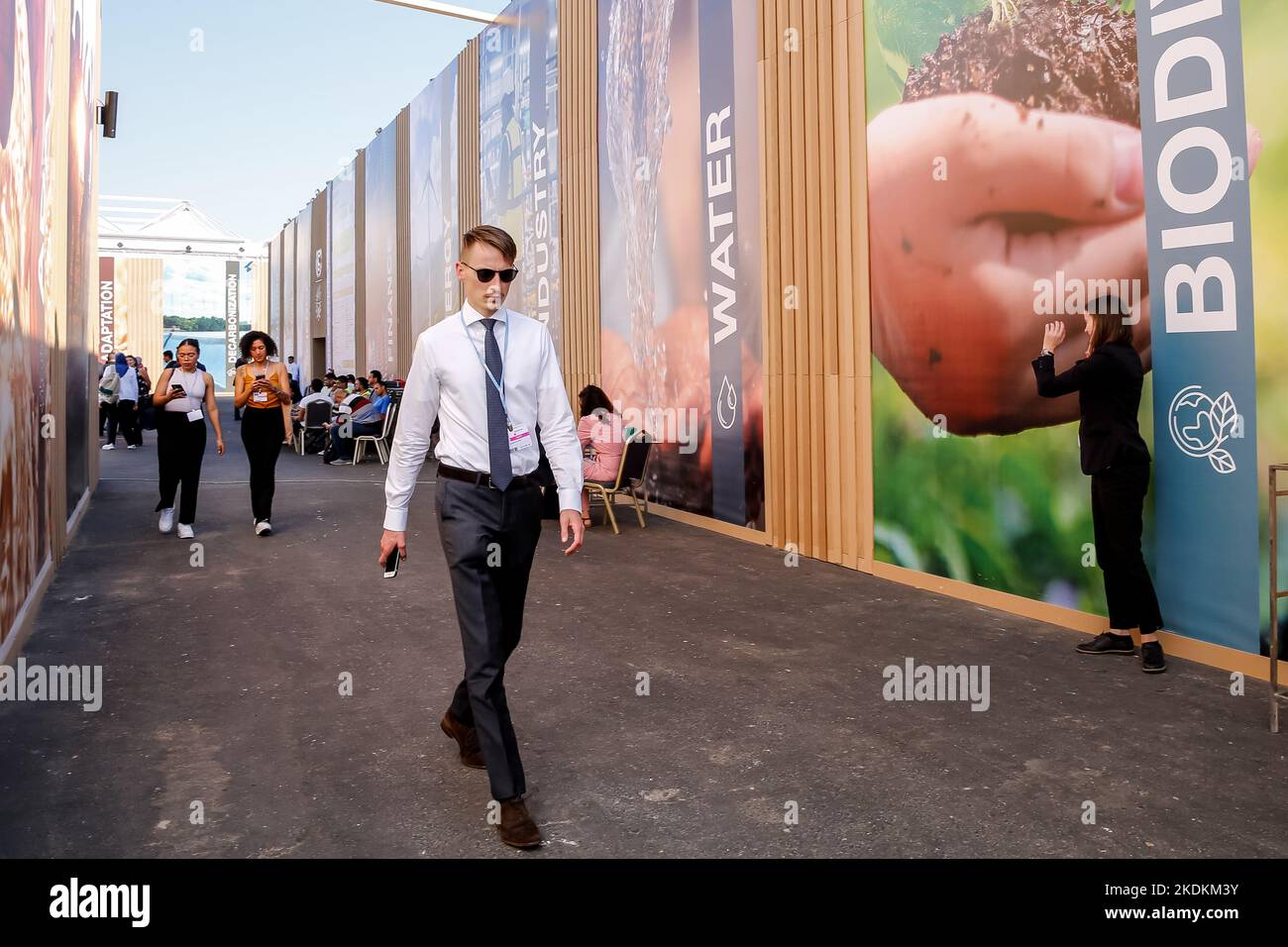 Participants walk in the Delegation Pavilions area on the second day of ...