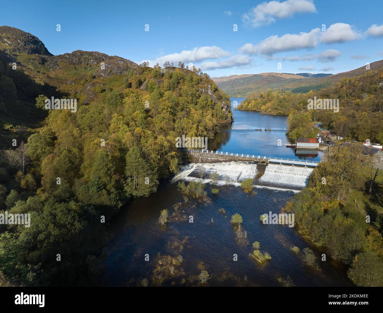 Aerial shot of the dam on Loch Katrine with several sluice gates open ...