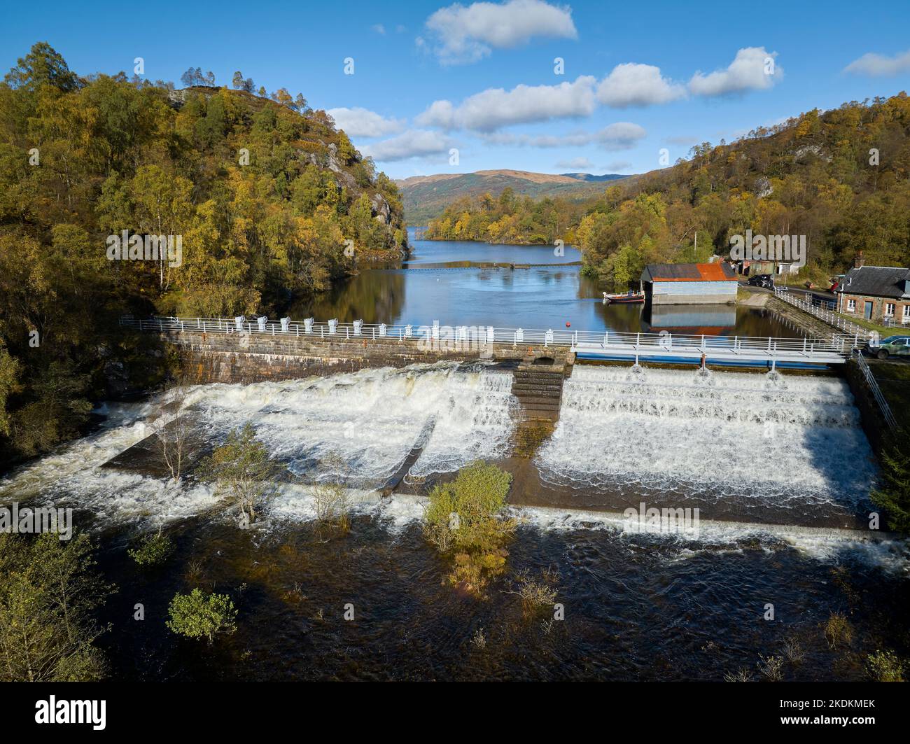 Aerial shot of the dam on Loch Katrine with several sluice gates open ...
