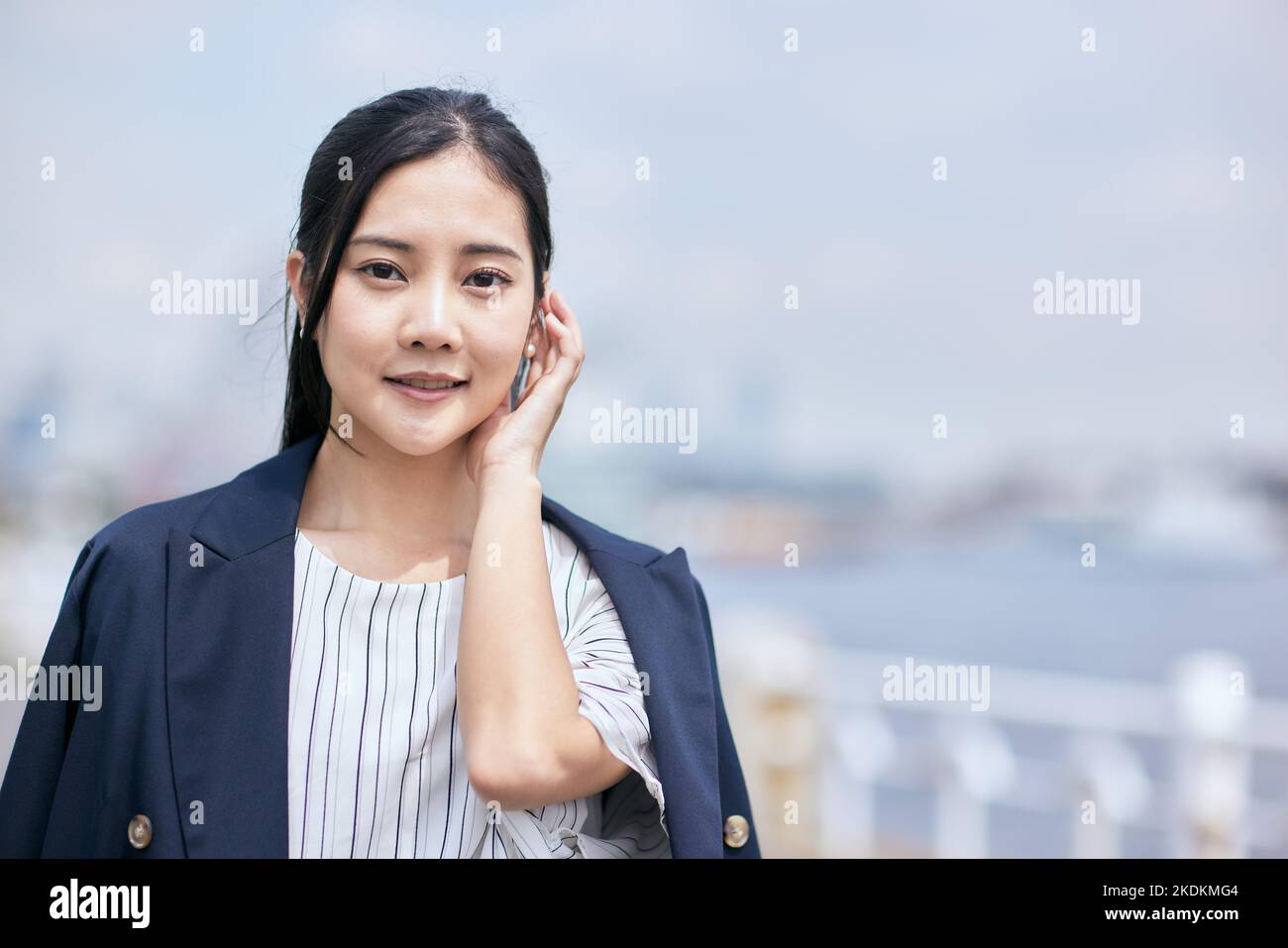 Positive asian woman putting hi-res stock photography and images - Alamy