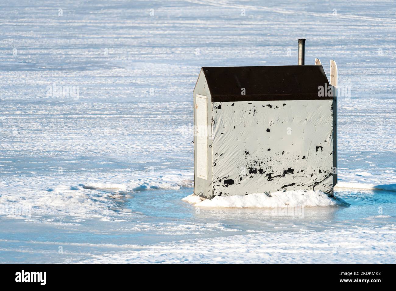 Ice fishing on a frozen harbor in rural Prince Edward Island, Canada ...