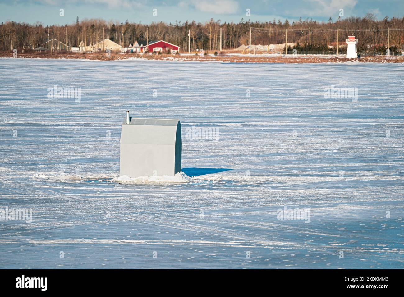 Ice fishing on a frozen harbor in rural Prince Edward Island, Canada ...