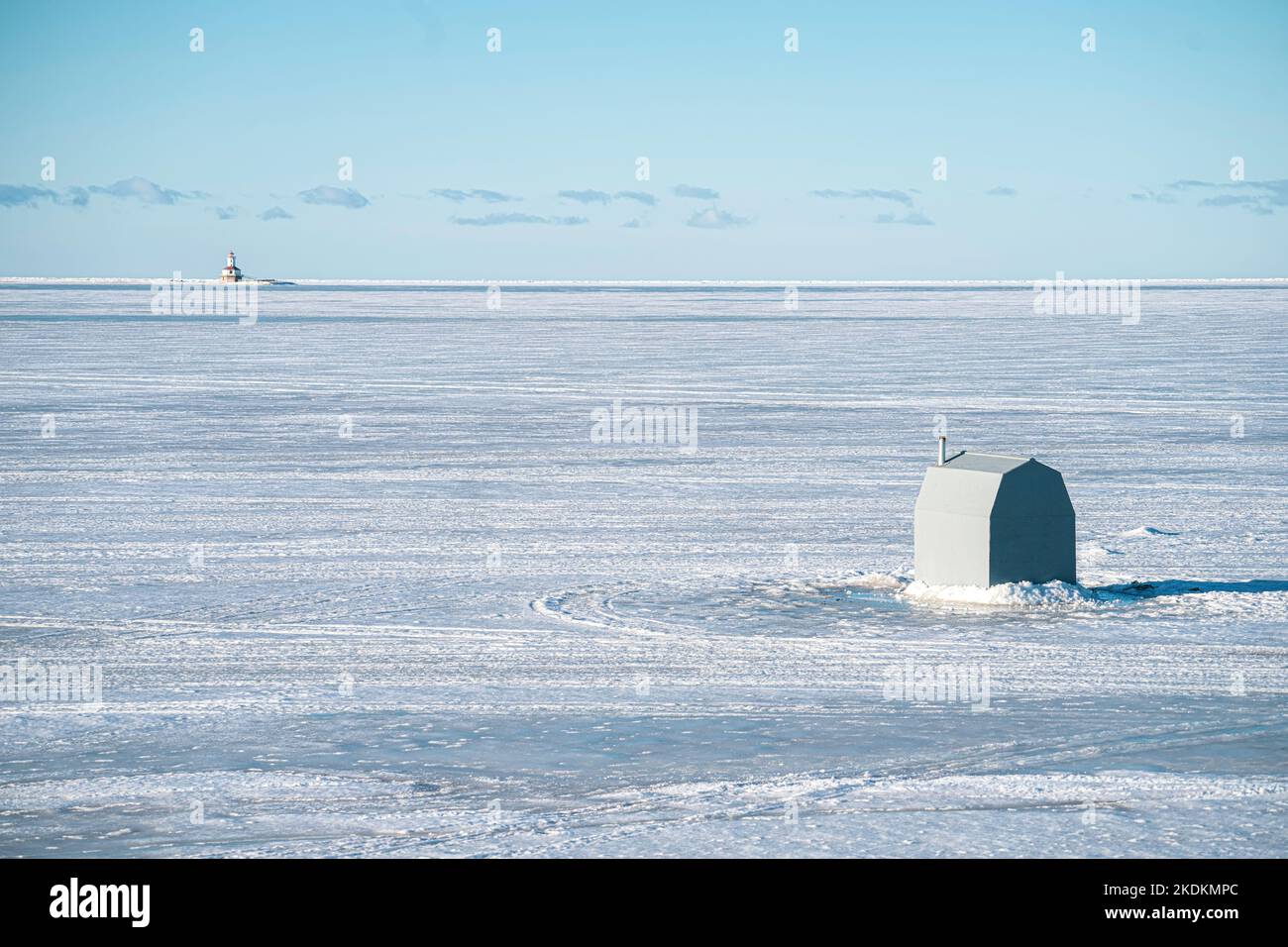 Ice fishing on a frozen harbor in rural Prince Edward Island, Canada ...