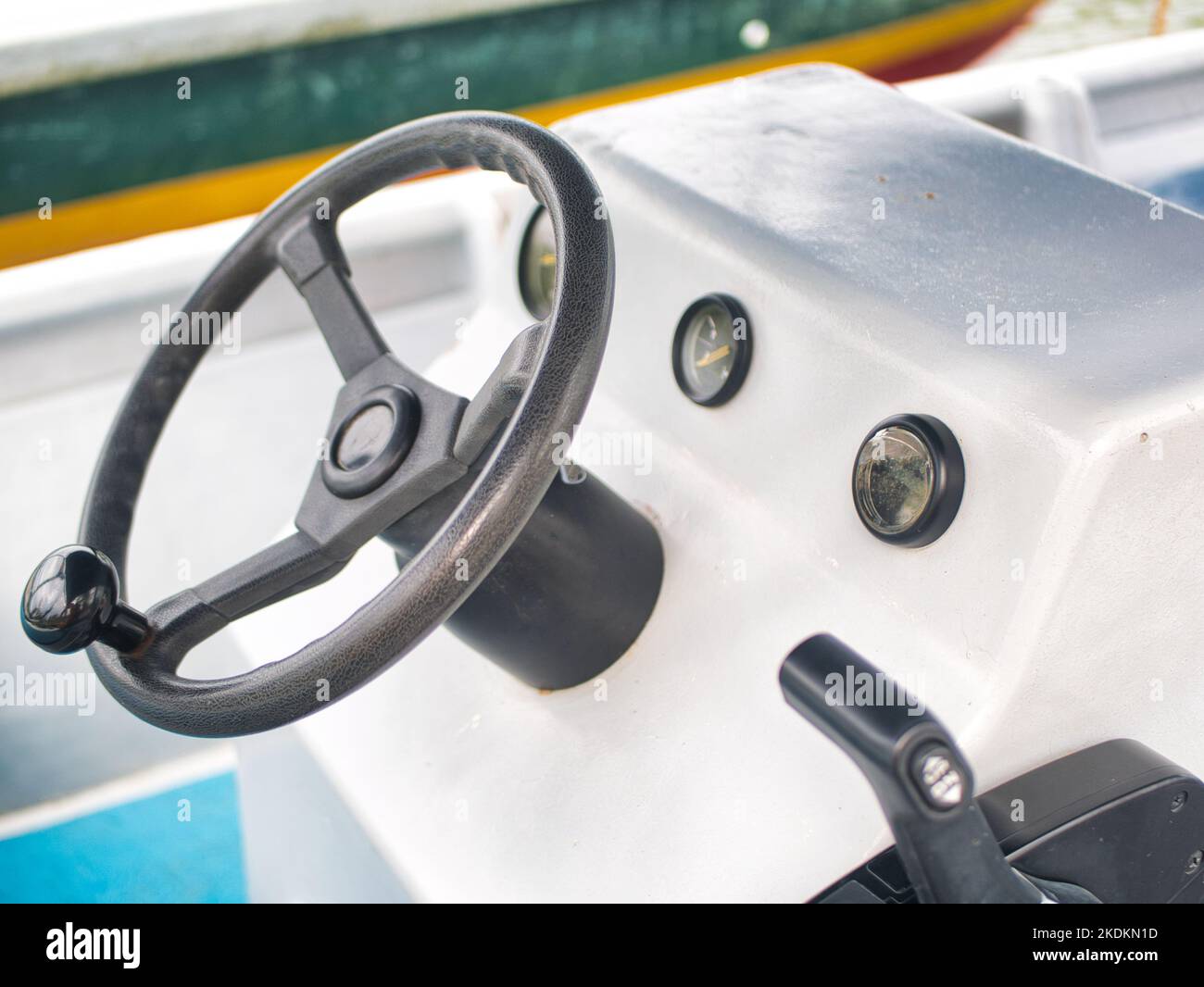 A boat steering wheel and lever with instrument panel Stock Photo - Alamy