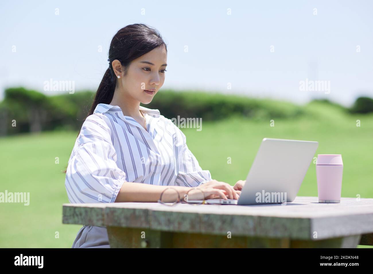 Young Japanese woman working outside Stock Photo - Alamy