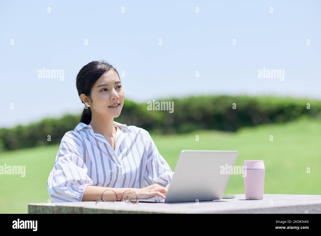 Young Japanese woman working outside Stock Photo - Alamy