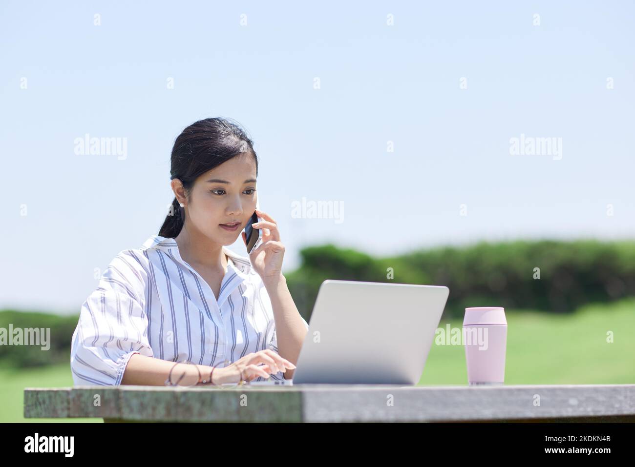 Young Japanese woman working outside Stock Photo - Alamy