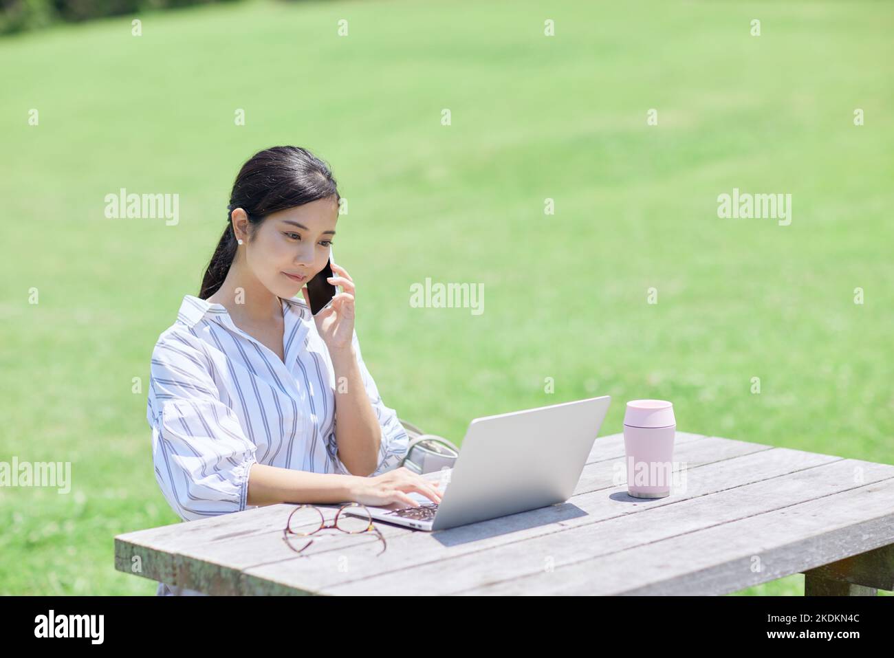 Young Japanese woman working outside Stock Photo - Alamy