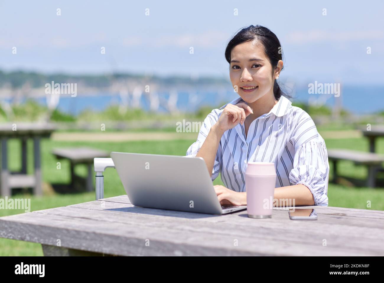 Young Japanese woman working outside Stock Photo - Alamy