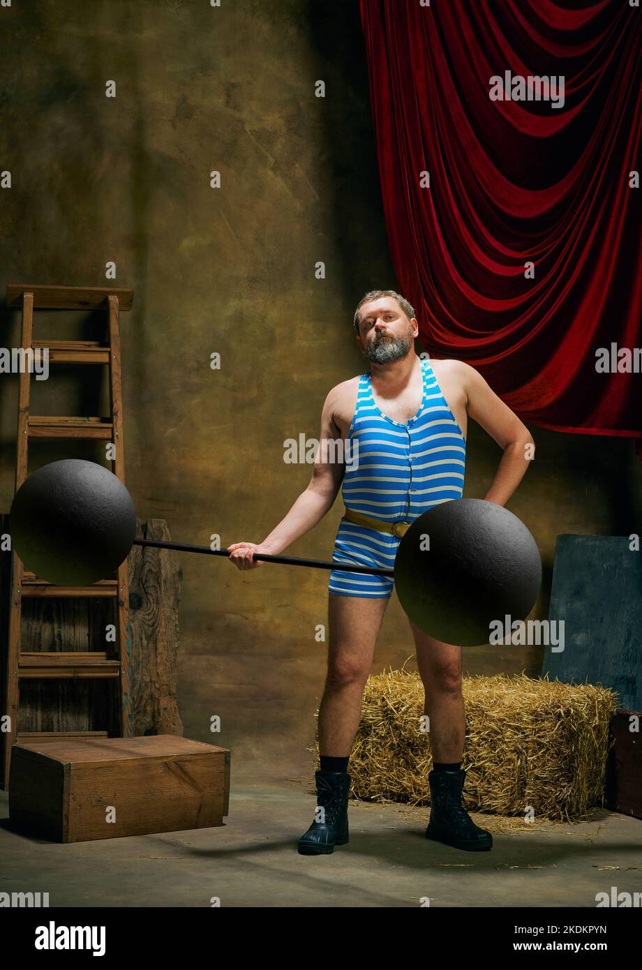 Retro circus. Cinematic portrait of retro circus strongman wearing ...