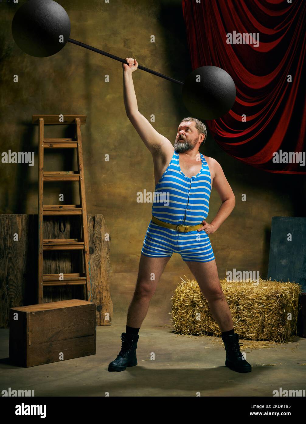 Strength. Overweight man, retro circus strongman wearing striped sports ...