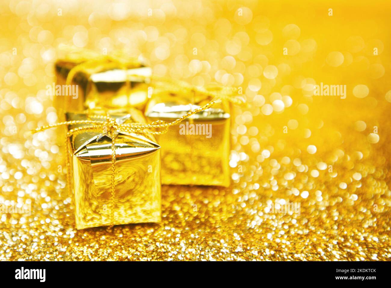 Gold decorative boxes with holiday gifts on abstract gold background ...
