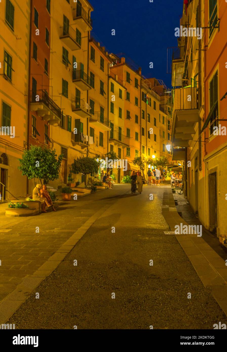 Night falls on Via Colombo as locals and tourists mingle in Riomaggiore ...