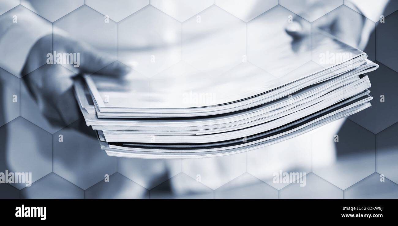 Female hands holding a stack of magazines, geometric pattern Stock ...