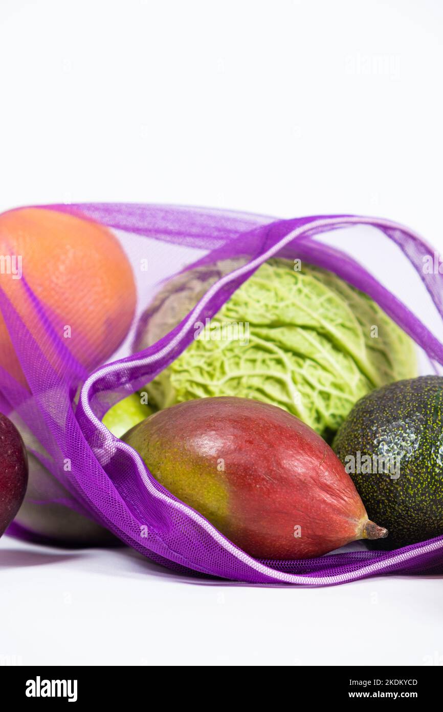 Fabric mesh for fruits and vegetables on a white background. A reusable ...