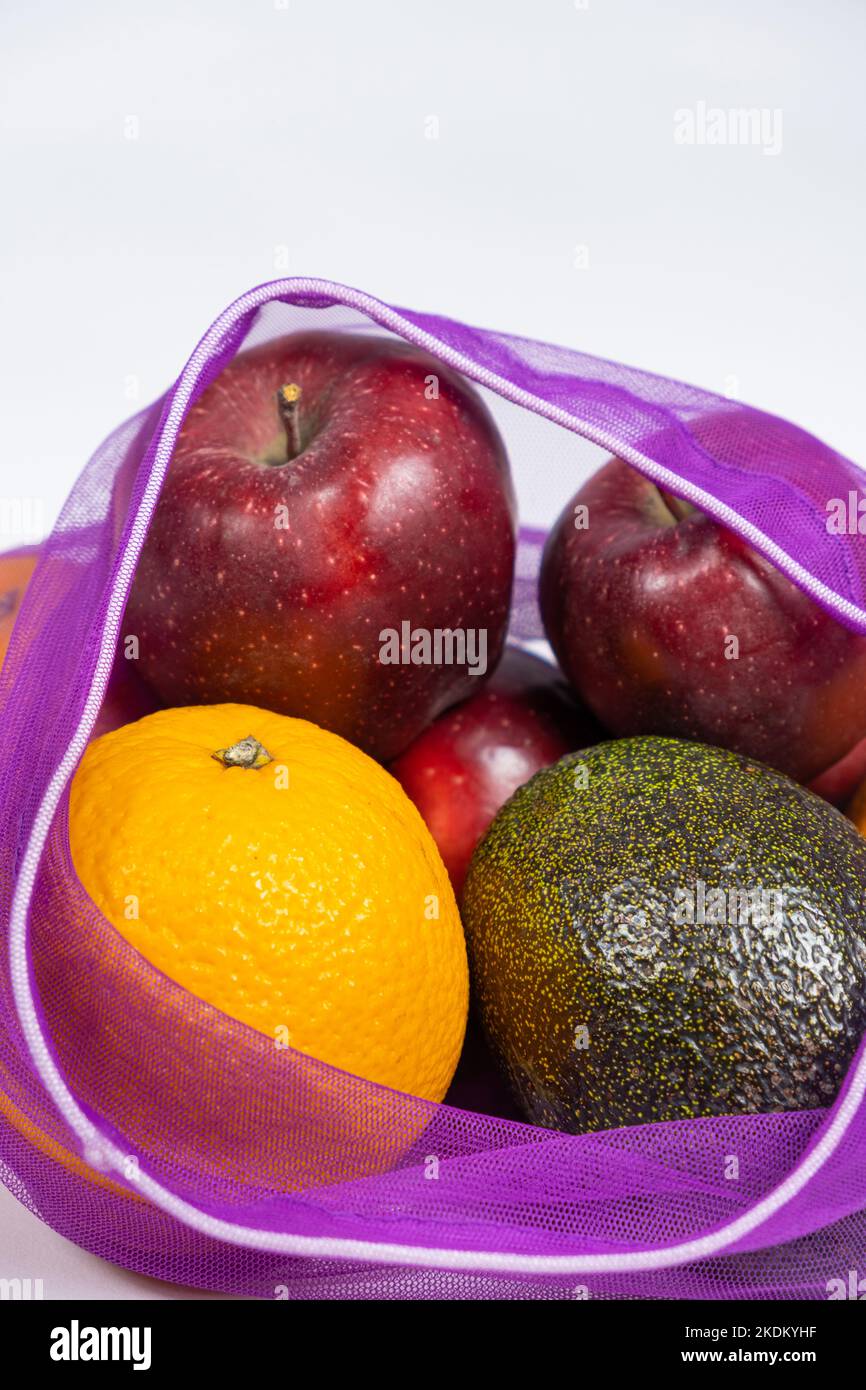 Fabric mesh for fruits and vegetables on a white background. A reusable ...