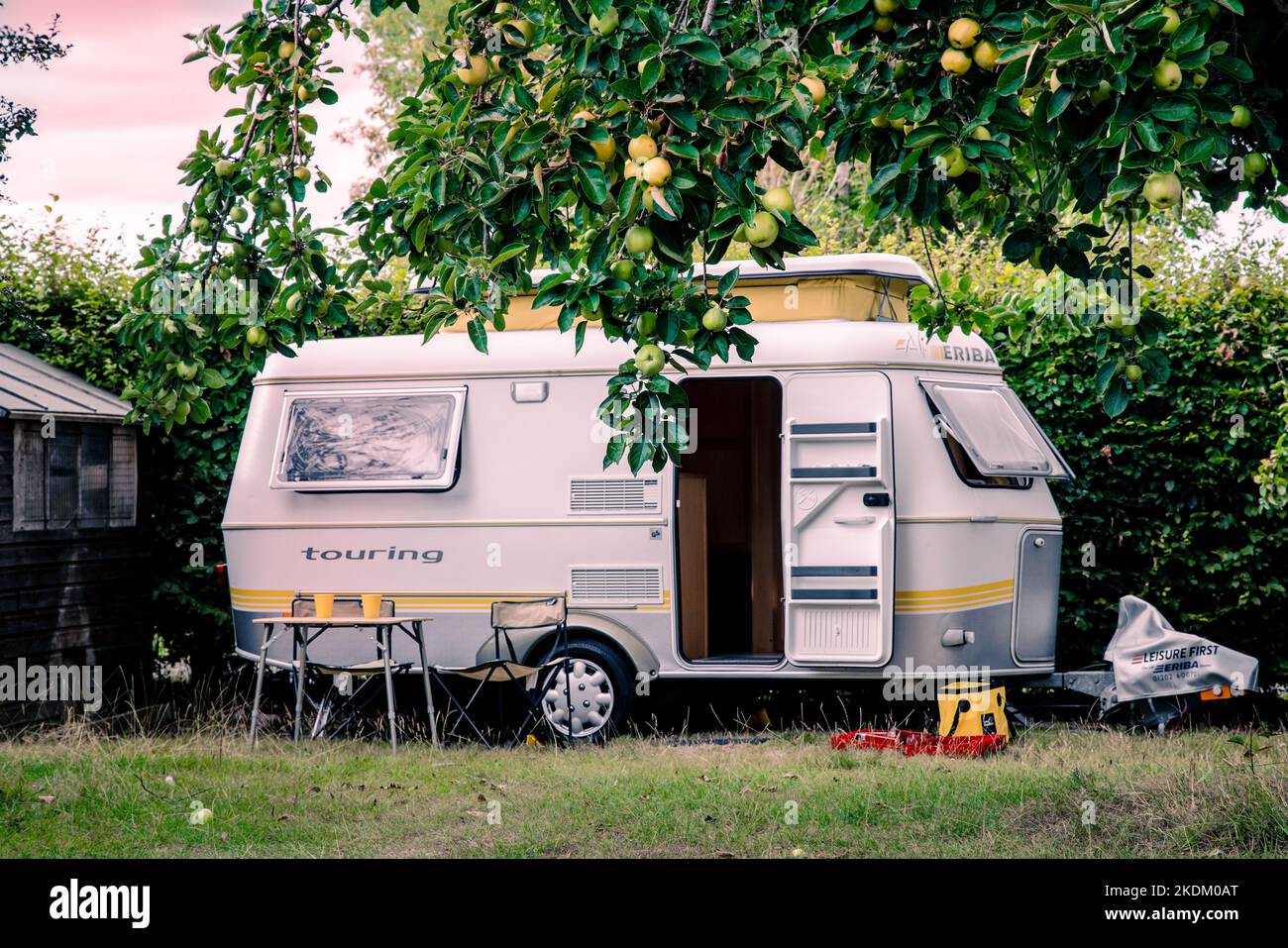 Caravan UK - a yellow touring Eriba Caravan, side view, with table and ...
