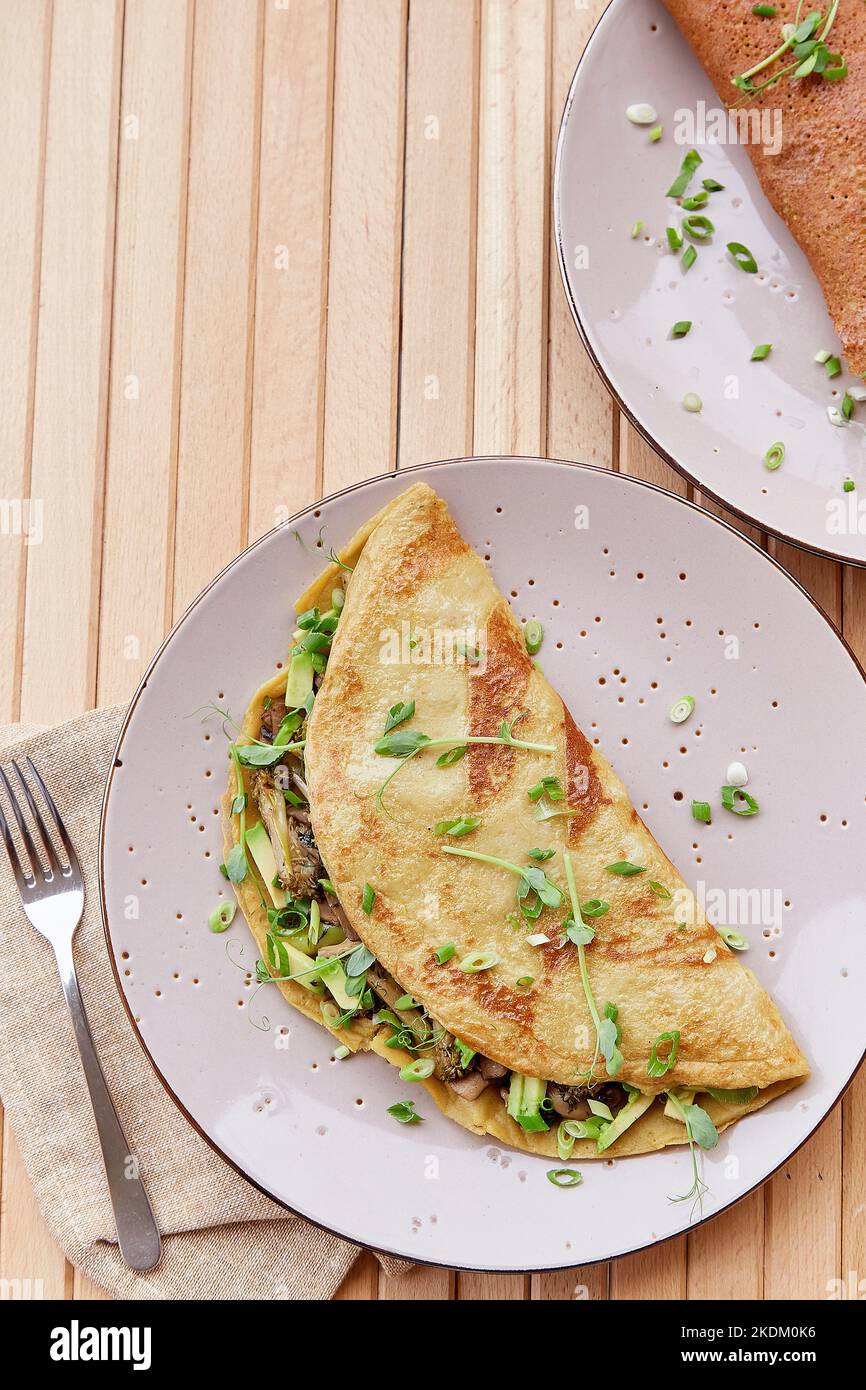 Vegan gluten, sugar free pancakes with mushrooms, pea sprouts, greens ...