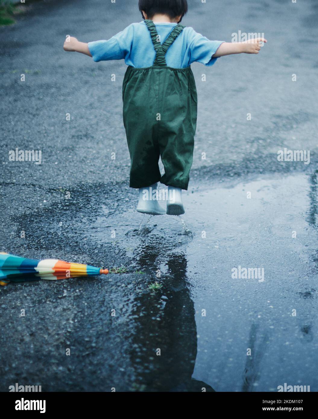 Japanese kid playing outside on a rainy day Stock Photo - Alamy