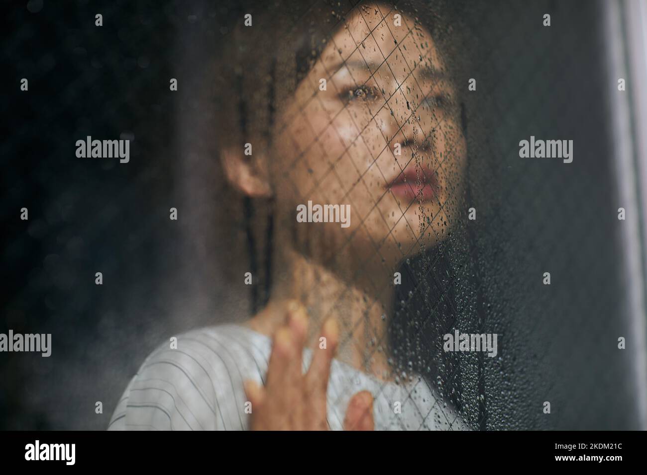 Japanese woman looking out the window Stock Photo - Alamy