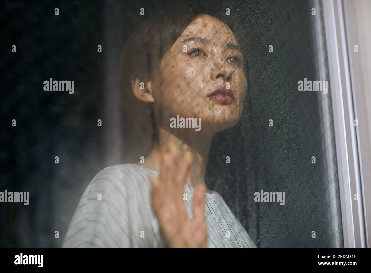 Japanese woman looking out the window Stock Photo - Alamy