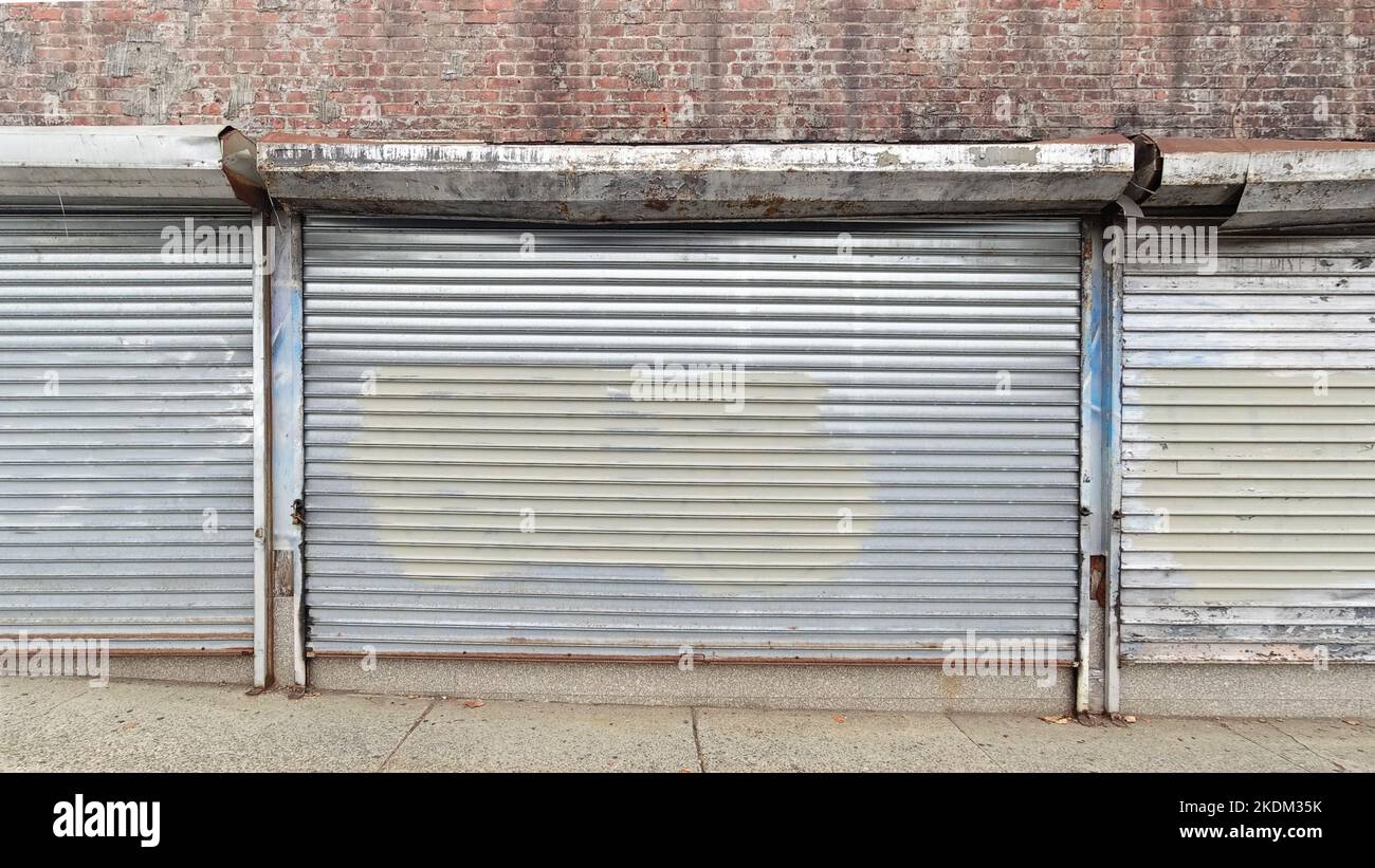 Plain steel roller window shutters with paint on a closed brick ...