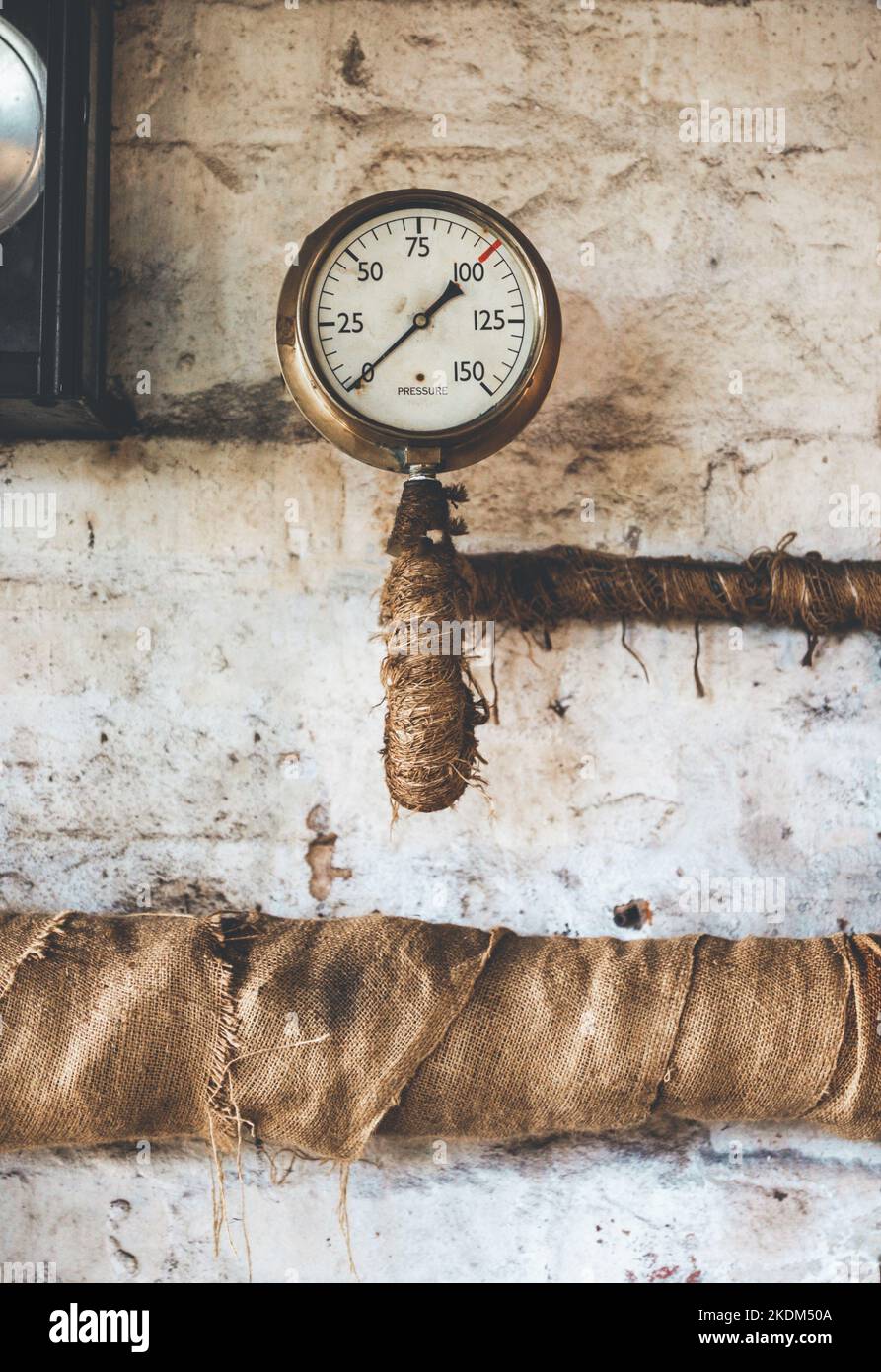 Steam engine pressure guage and lagged pipes Stock Photo - Alamy