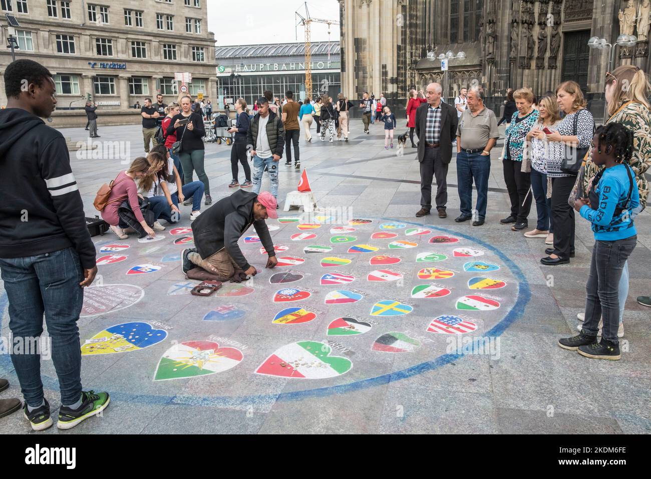 painting of a pavement painter in front of the cathedral, flags of ...