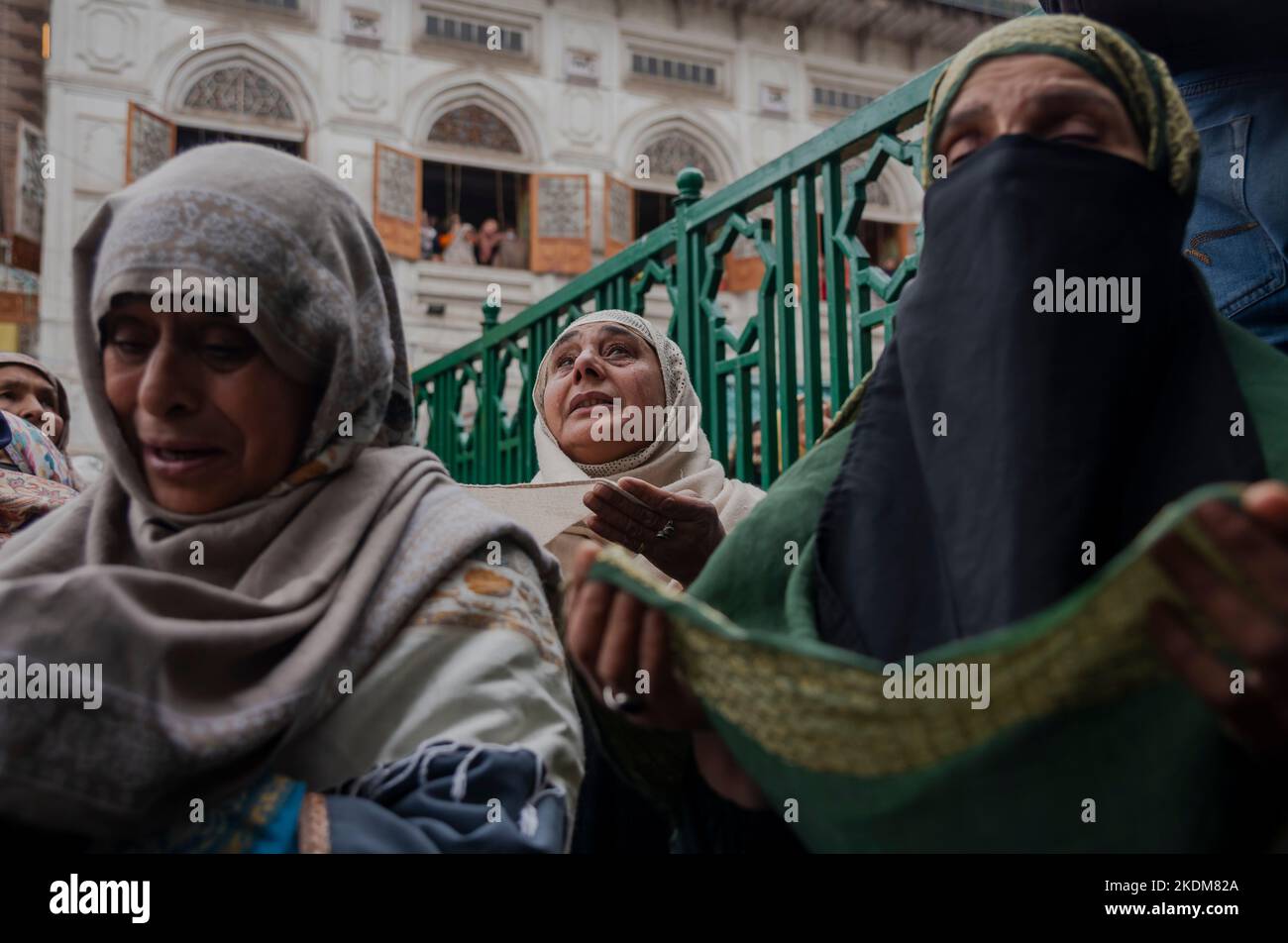 Kashmiri Muslims raise their hands while beseeching for blessings as ...