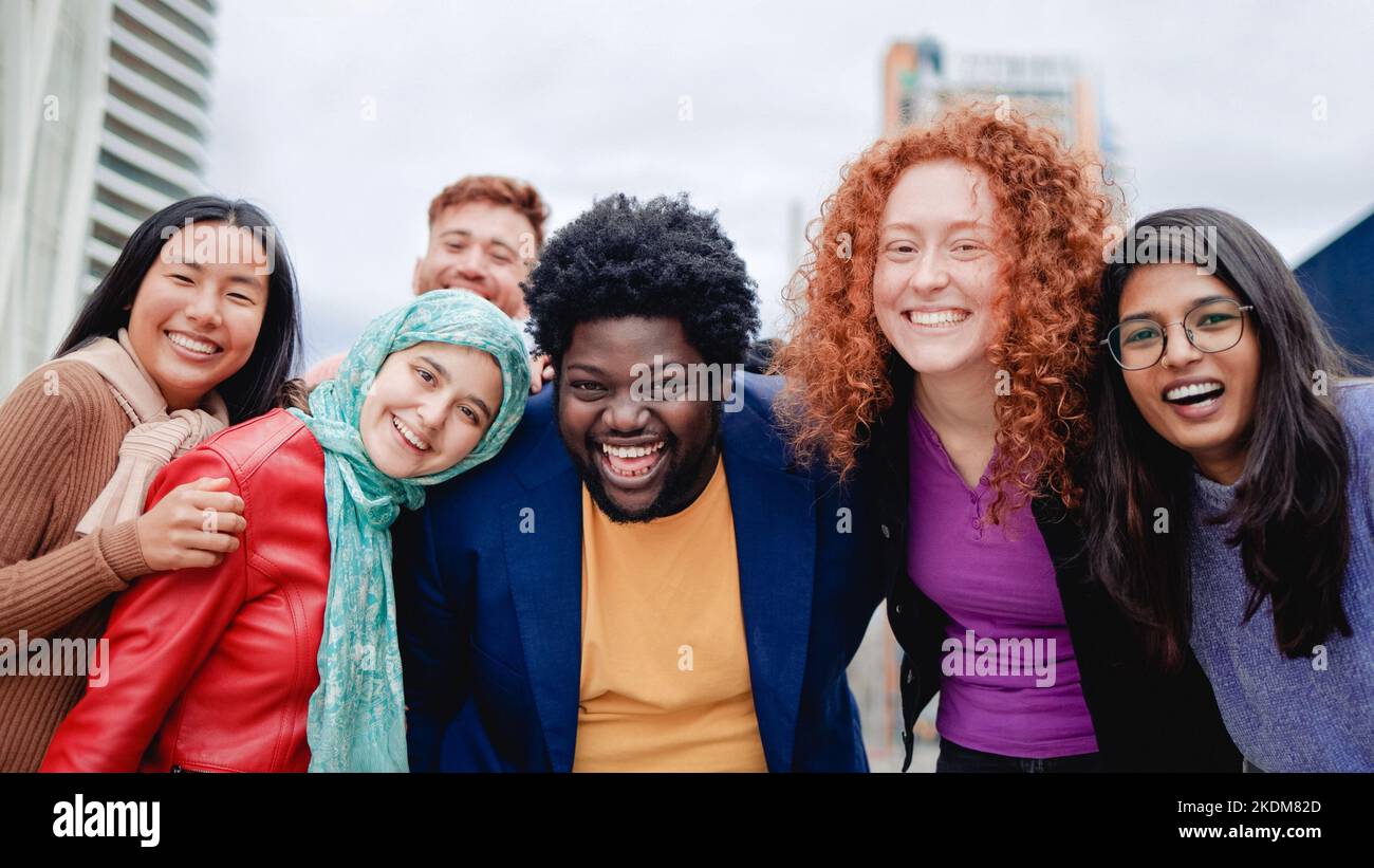 Multiracial happy group of friends having fun outdoors in the city ...
